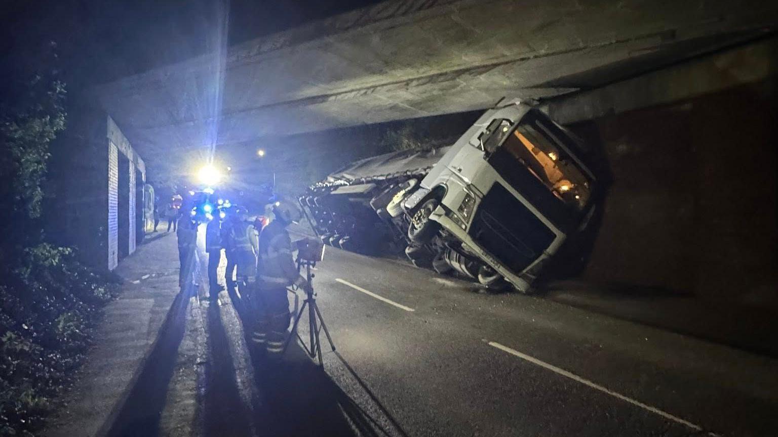 Lorry tips on side after striking Newport railway bridge - BBC News