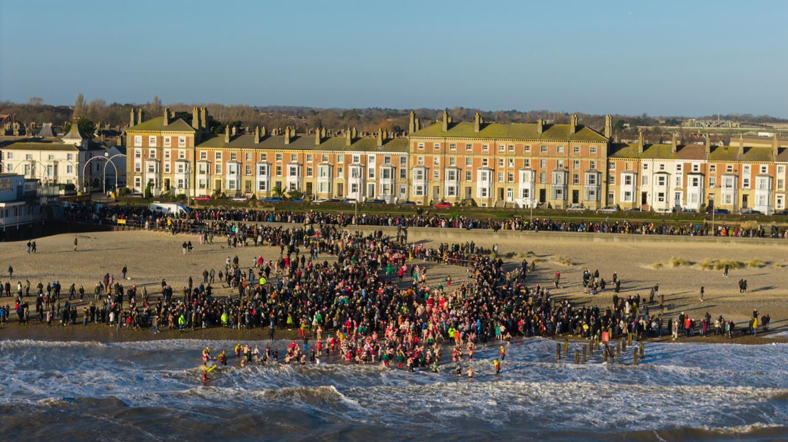 Swimmers brave chilly conditions for Lowestoft Christmas Day dip - BBC News