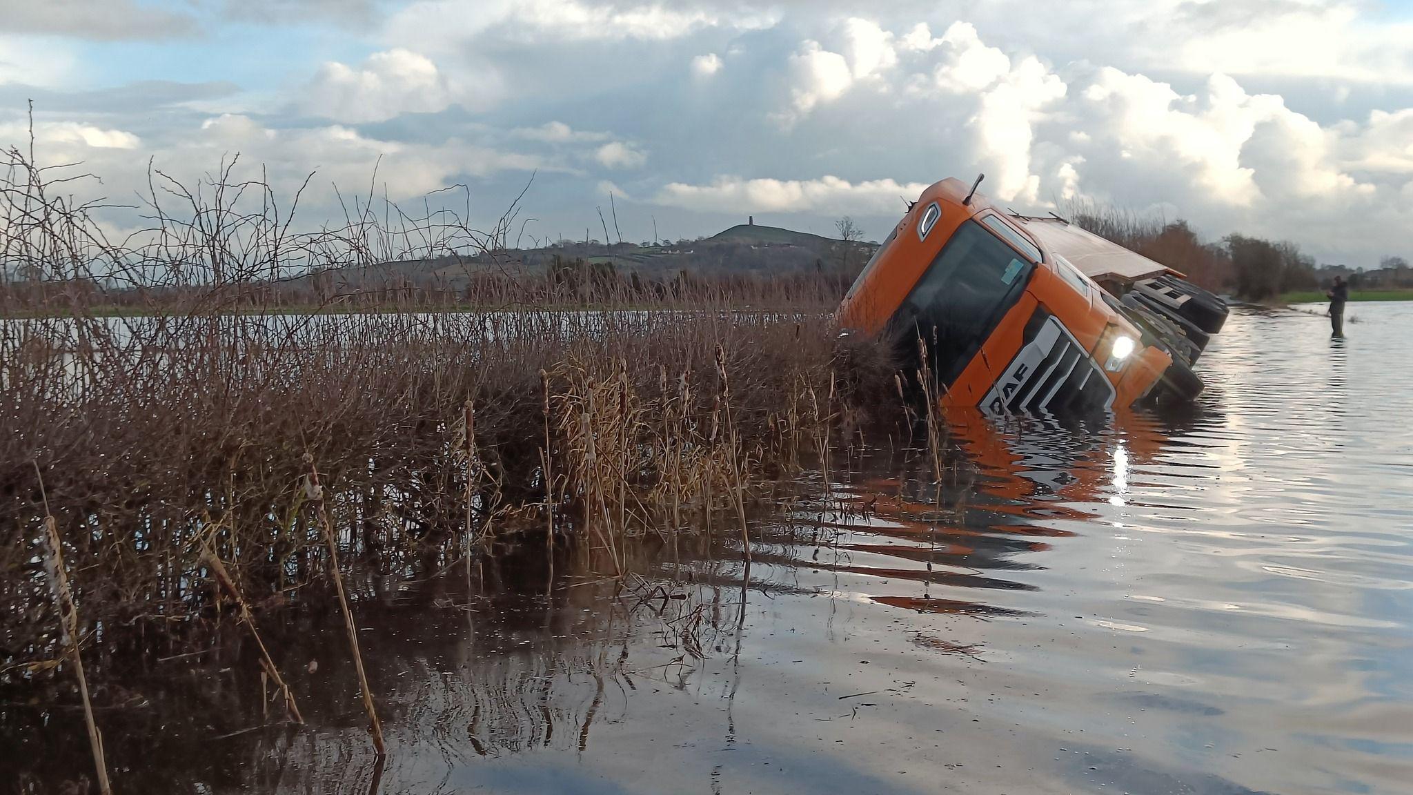 Lorry driver rescued after getting stuck in Somerset flood - BBC News