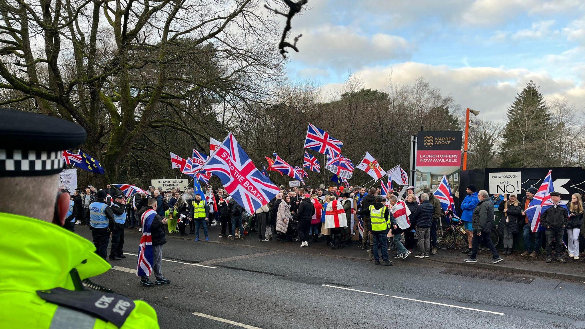 Hundreds protest against asylum plans at Crowborough army camp - BBC News
