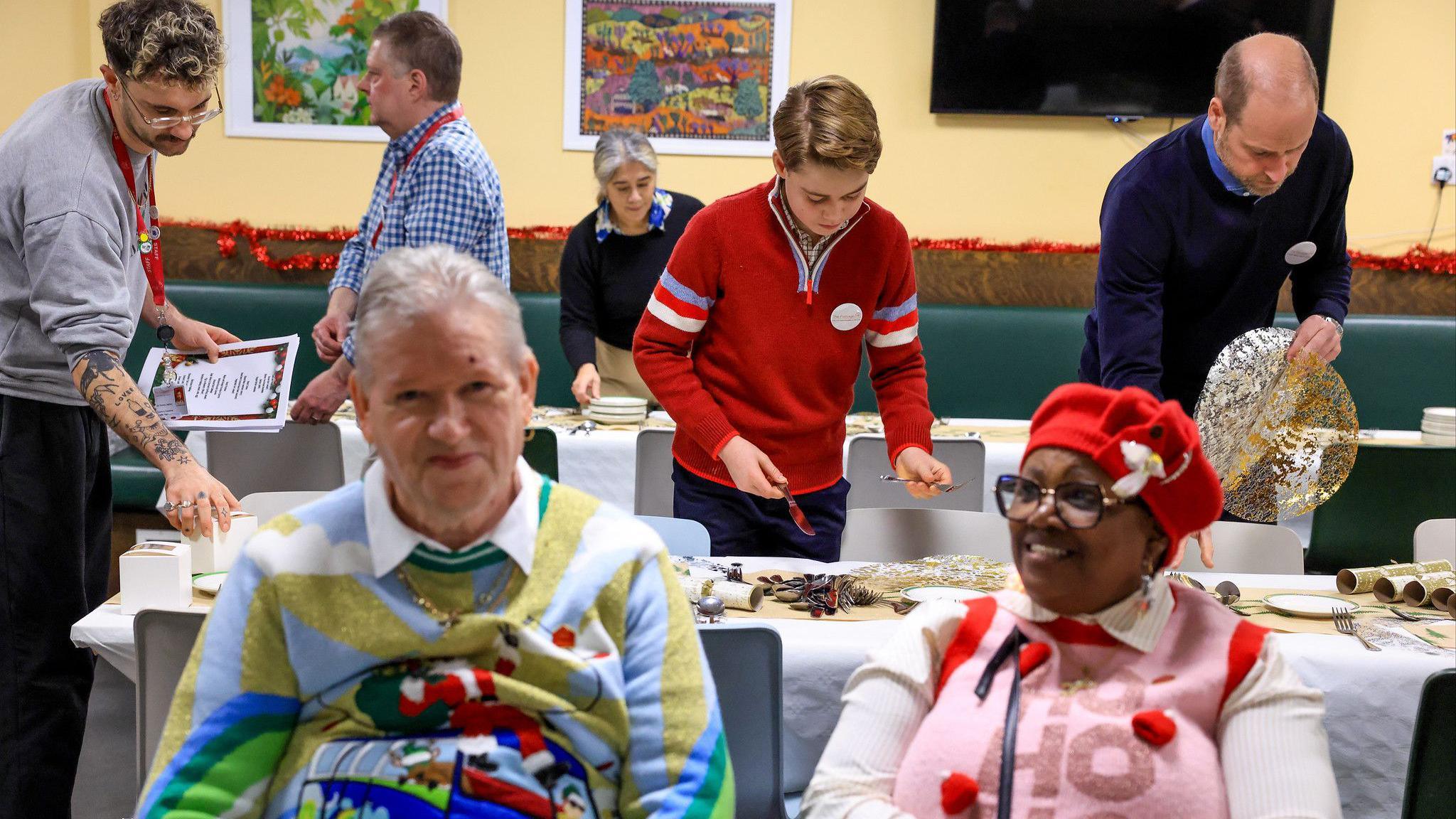 George joins Prince William in preparing meal for homeless - BBC News