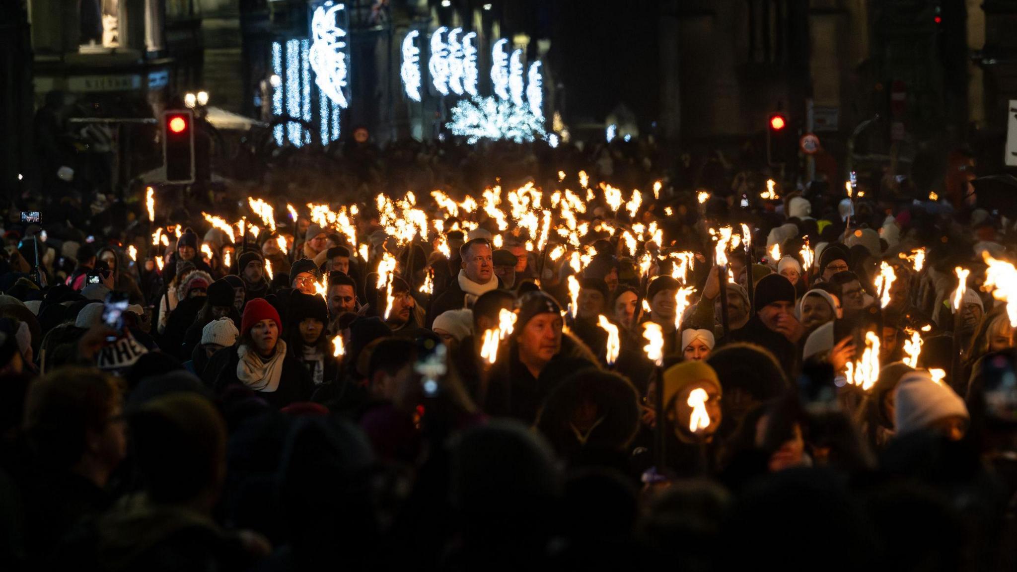 Torchlight procession kicks off Edinburgh's Hogmanay celebrations - BBC ...