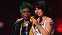 Raye: Singer-songwriter makes history winning six Brit Awards - BBC News