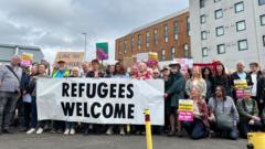 Demo and counter-demo meet outside migrant hotel in Gloucester - BBC News