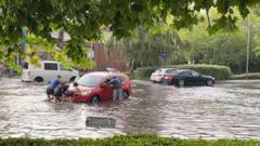 Guildford: Cars stranded after storms bring floods - BBC News