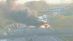 M56 lorry fire: Crews tackle 'thick smoke' as motorway closes - BBC News