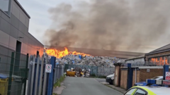 Huyton: Residents told to shut windows as huge fire rages - BBC News
