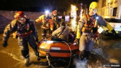 Lethal storm and tidal surge sees thousands out of homes - BBC News