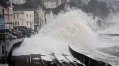 UK storms destroy railway line and leave thousands without power - BBC News