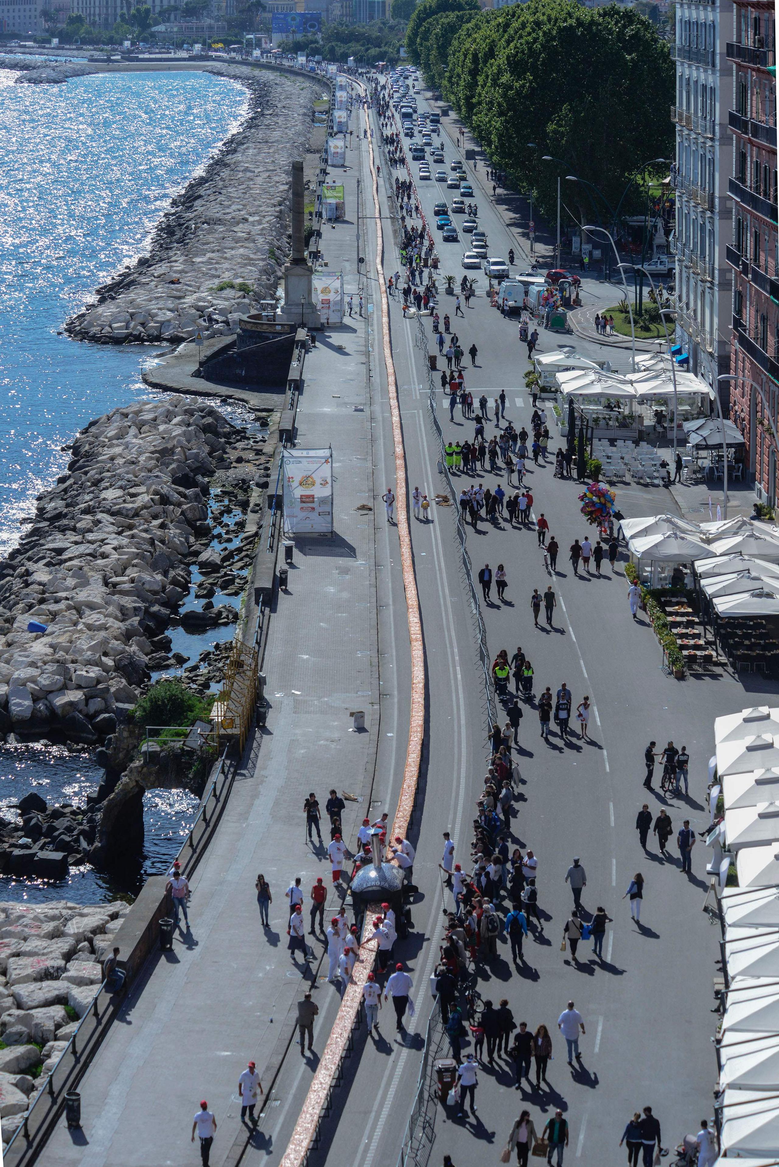 Pictures: Guinness World record set for longest pizza ever - BBC Newsround