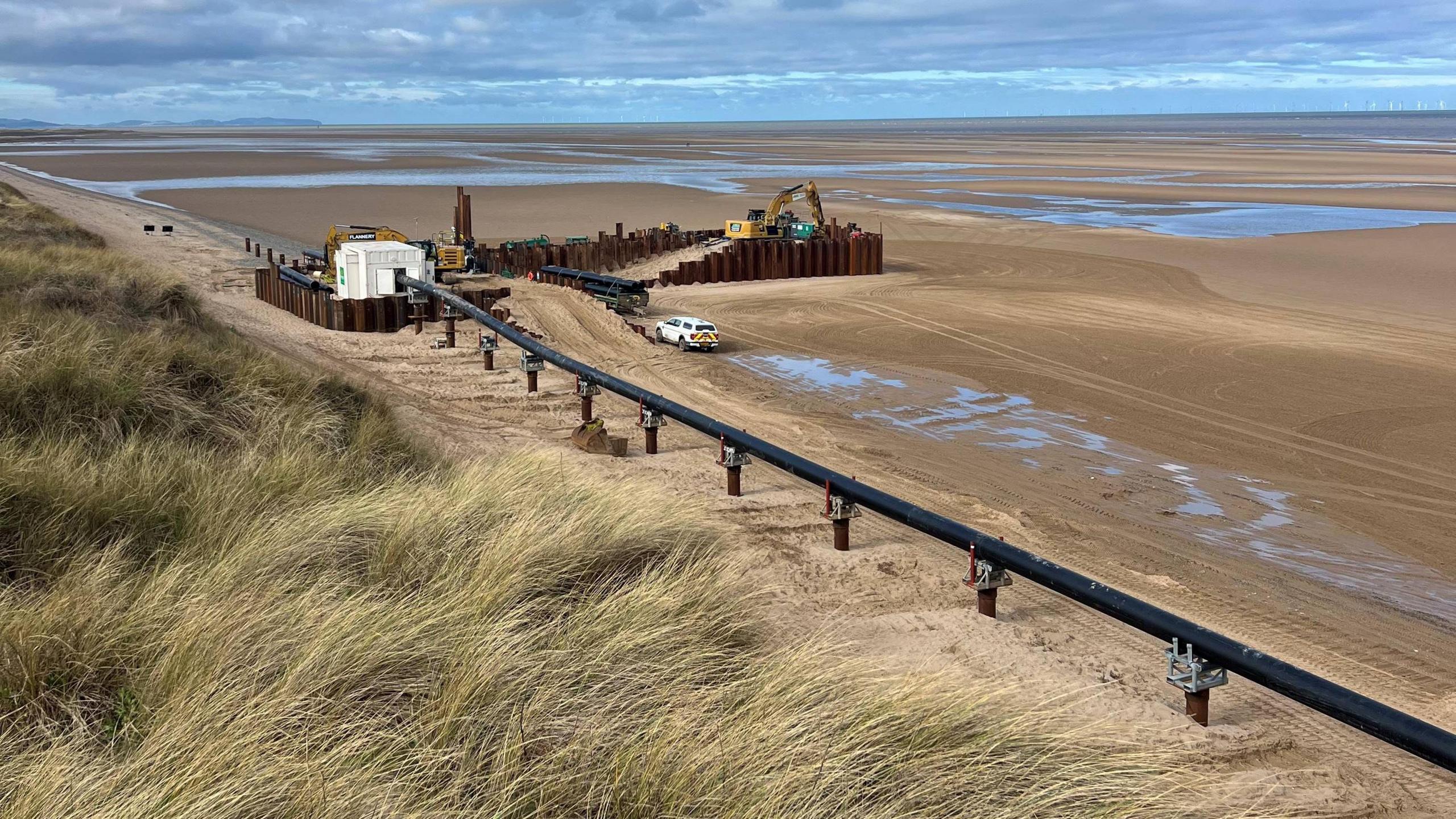Talacre beach giant pipe across sand shocks visitors - BBC News