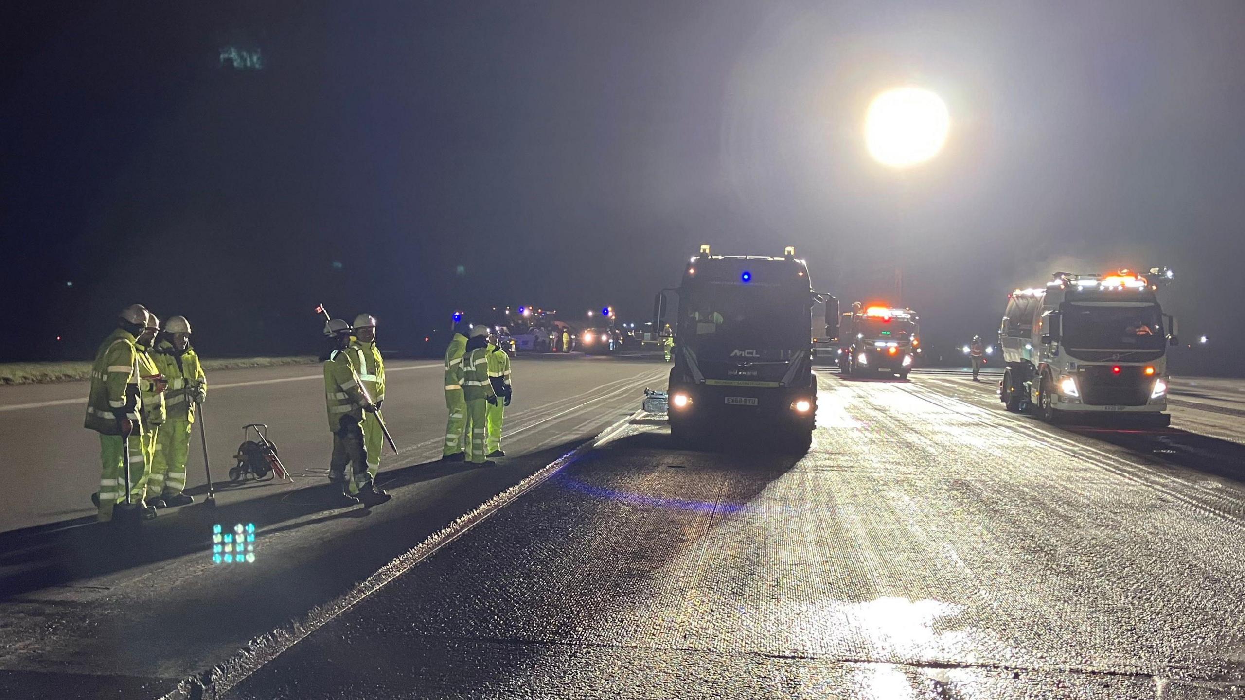 The team working to resurface a runway at Luton Airport - BBC News