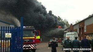 Crews remain at Darlington garage fire scene - BBC News