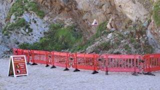 Access to Newquay beach is restricted after cliff fall - BBC News