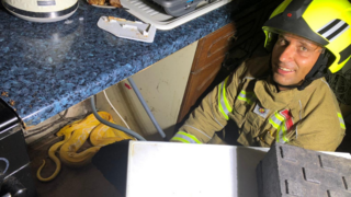 Ampthill python sssstuck under oven rescued by fire crew - BBC News