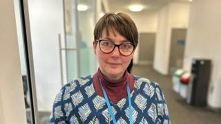 Facing never-ending queues on the debt front line - BBC News