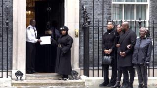 Thousands march in London over deaths in custody and riots - BBC News