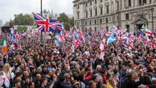 Thousands march in London over deaths in custody and riots - BBC News