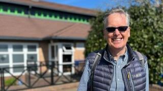 Warrington school pupils take part in protest to save library - BBC News