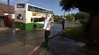 Double-decker bus stuck in hole in Holbrook - BBC News