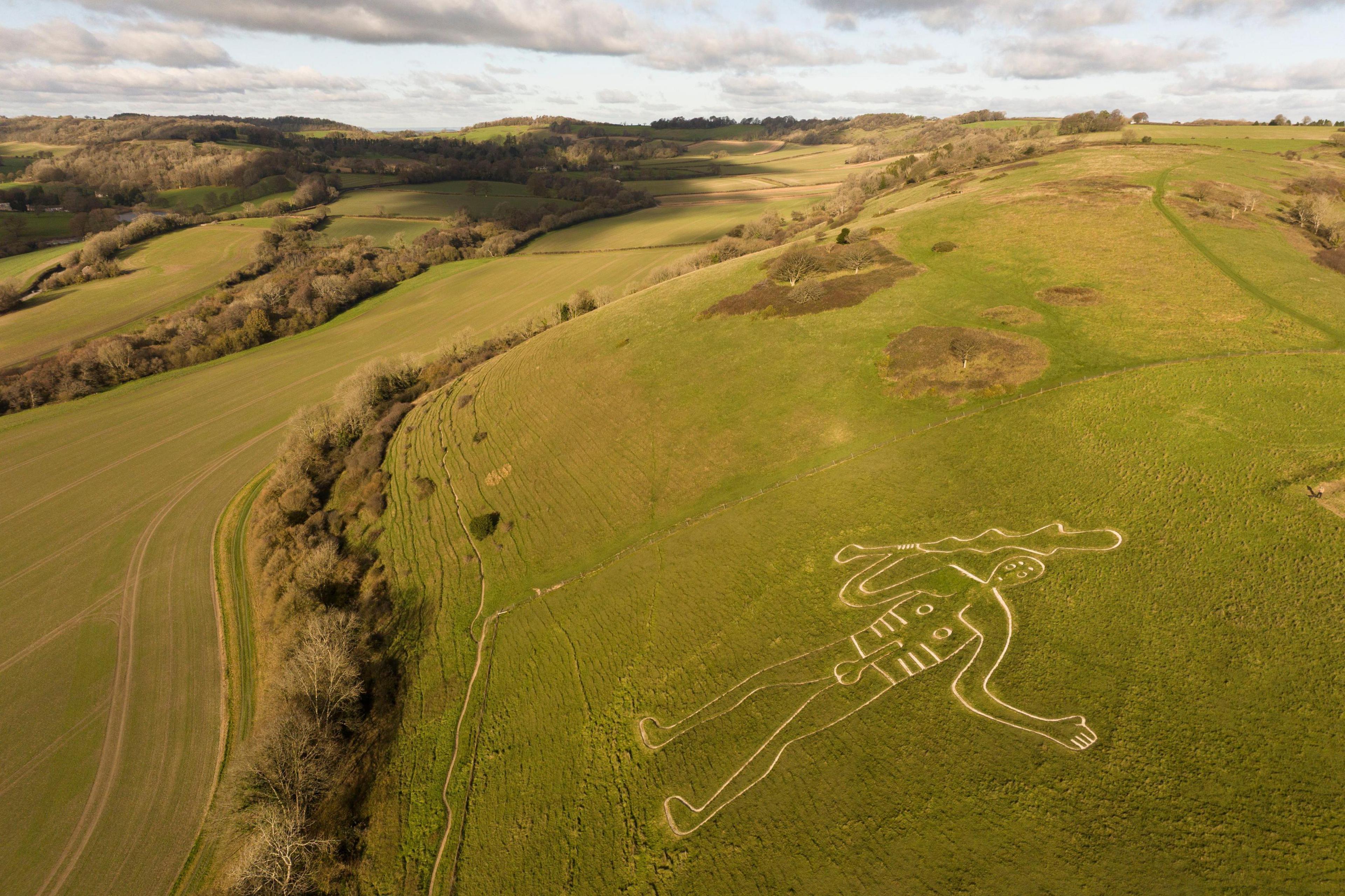 Fundraising pin badge reveals Cerne Abbas giant's cheeky side - BBC News