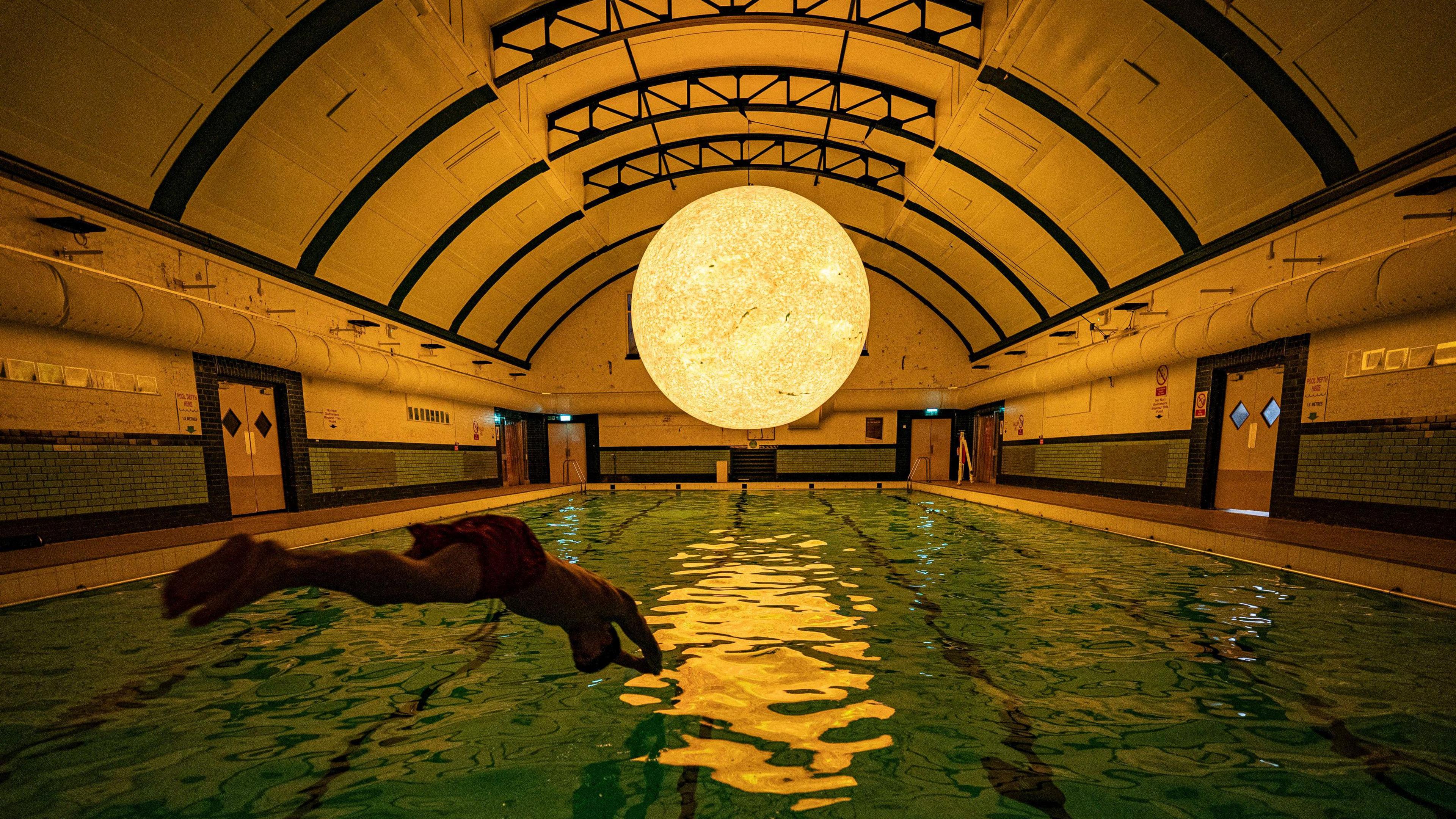 Luke Jerram's sun-inspired sculpture on display at Bristol pool - BBC News