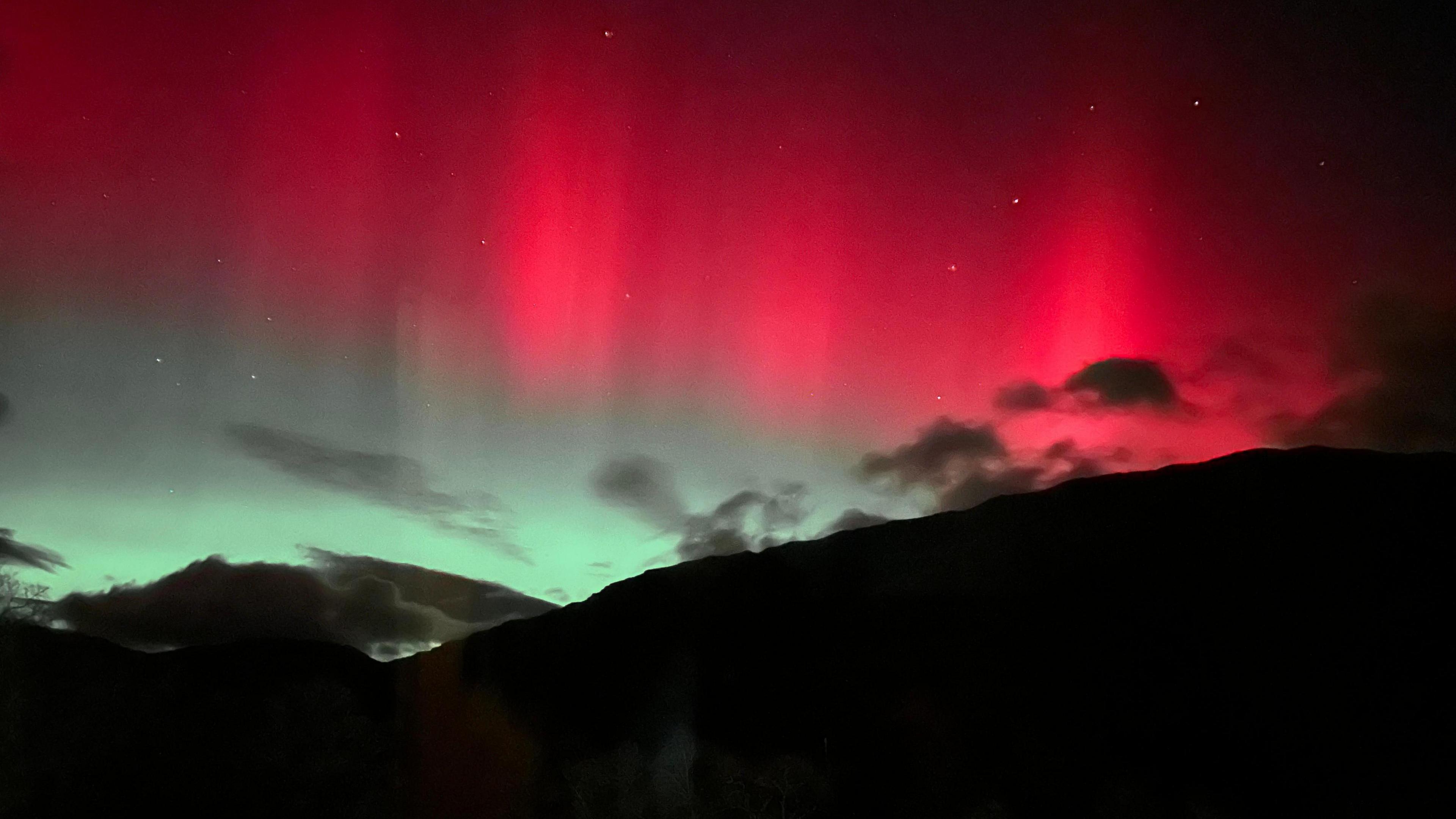 Rare red-toned Aurora Borealis lights up skies across Scotland - BBC News