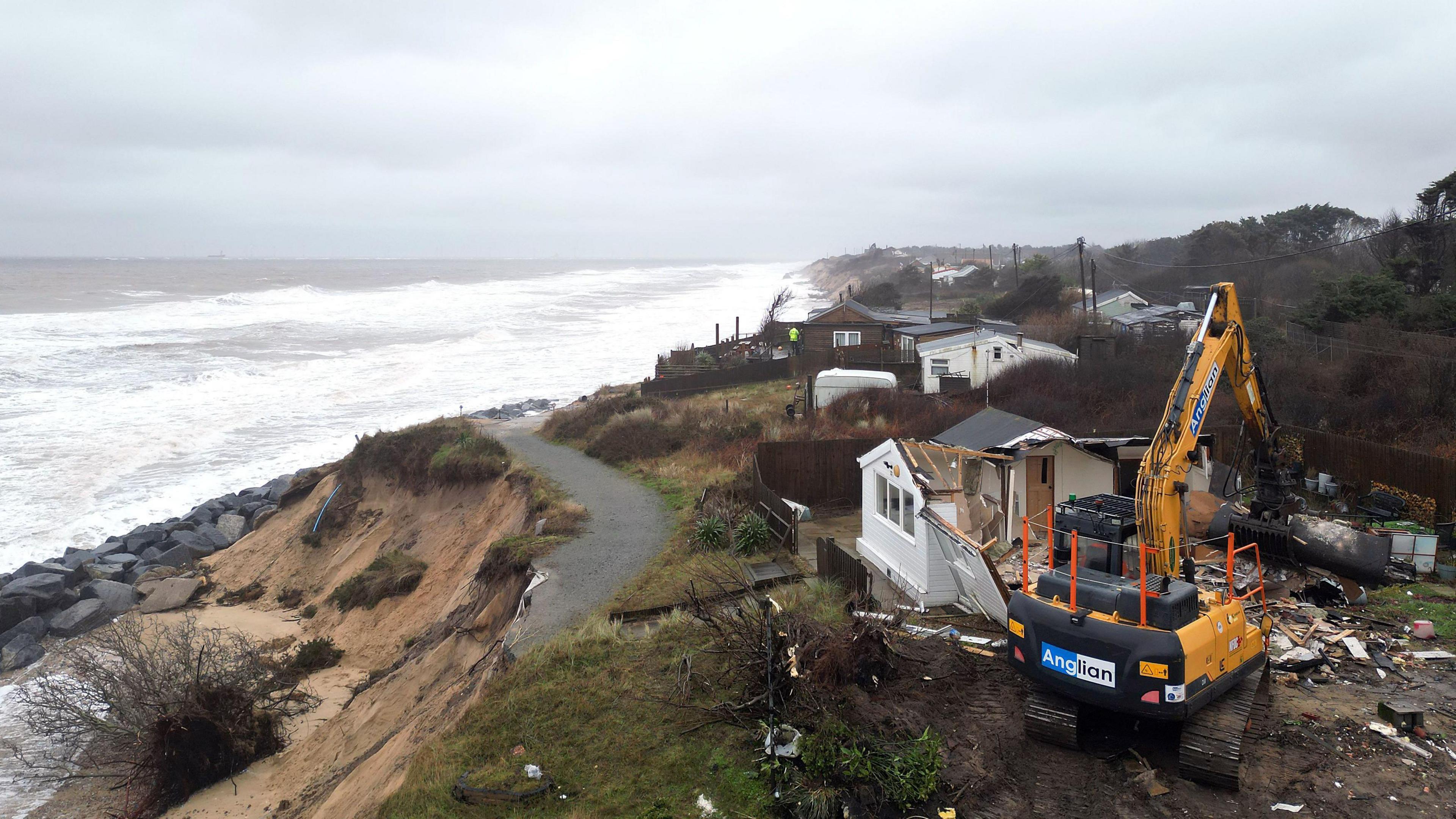 Hemsby clifftop demolition continues as residents move out - BBC News