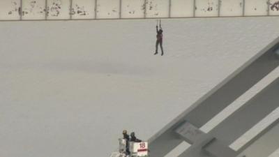 Worker left dangling from Houston bridge - BBC News