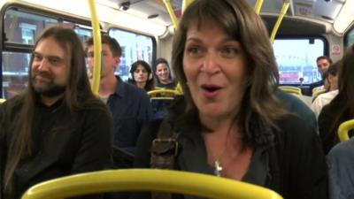 Guerrilla singers surprise bus passengers for art - BBC News