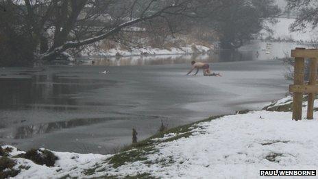 Man in underwear crawls over frozen river to rescue dog - BBC News