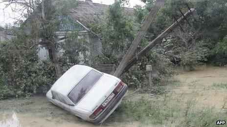 A handout photo taken on July 7, 2012 and released by Russia"s Interior Ministry shows a stranded car on a flooded street of the city of Krymsk