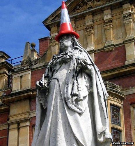 Why do people put traffic cones on statues? - BBC News