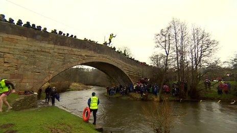 Mapleton Bridge jump: People take part in Ashbourne tradition - BBC News