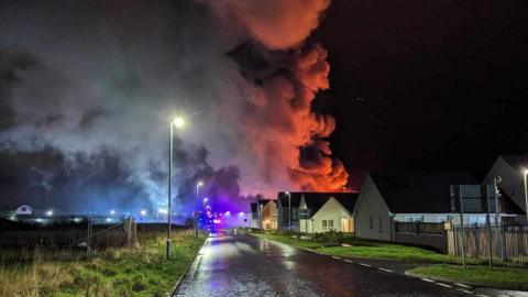 Firefighters spend second night at Kilwinning battery plant blaze - BBC ...