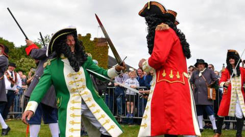 In pictures: Thousands turn out to annual Scarva Sham Fight - BBC News