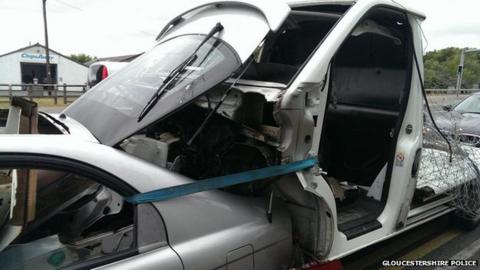 Gloucester driver caught towing van-strapped-in-car-boot - BBC News