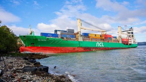 Man in Norway wakes to find huge container ship in garden - BBC News