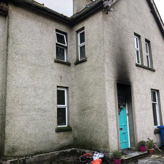 Portrush fire: Woman rescued from burning house by neighbour - BBC News