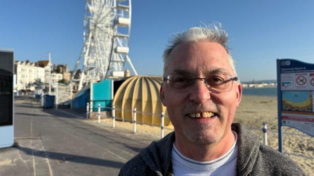 First passengers ride divisive Weymouth beach observation wheel - BBC News