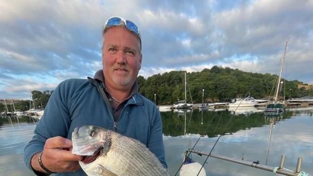 Devon skipper releases seahorse after catching it on fishing pot - BBC News