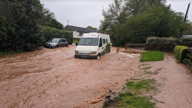 Flood water cascades down streets in Hertfordshire after thunderstorms ...