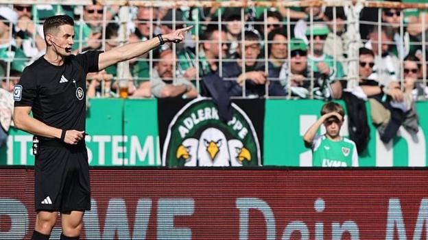VAR: Masked fan unplugs monitor in German second division match - BBC Sport