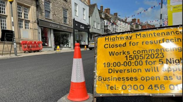 Potholes repaired after teenager places spoof golf sign - BBC News