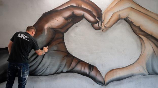 Peterborough: Artist transforms street with 'positive' mural - BBC News