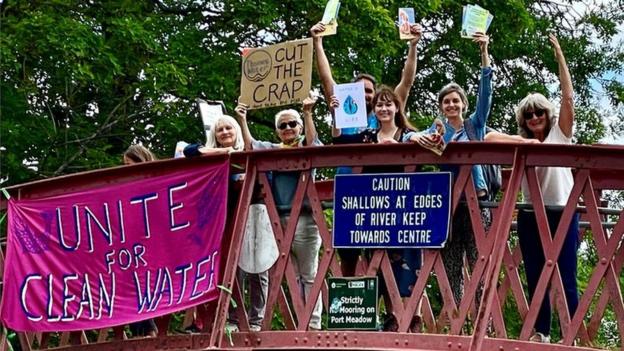 Dozens join protest against sewage discharges into rivers - BBC News