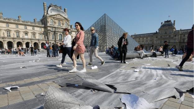 Louvre's giant paper artwork shredded in hours by visitors' footsteps ...