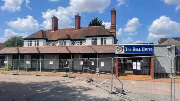 Hundreds of protesters gather at asylum hotel in Norwich area - BBC News