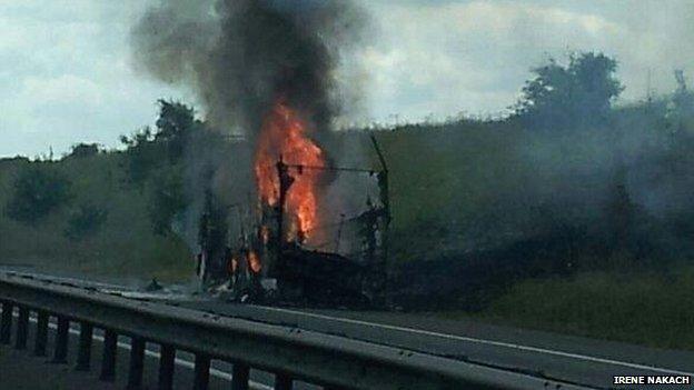Double decker bus on M11 gutted by fire in Essex - BBC News