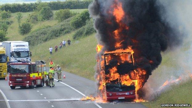 Double decker bus on M11 gutted by fire in Essex - BBC News